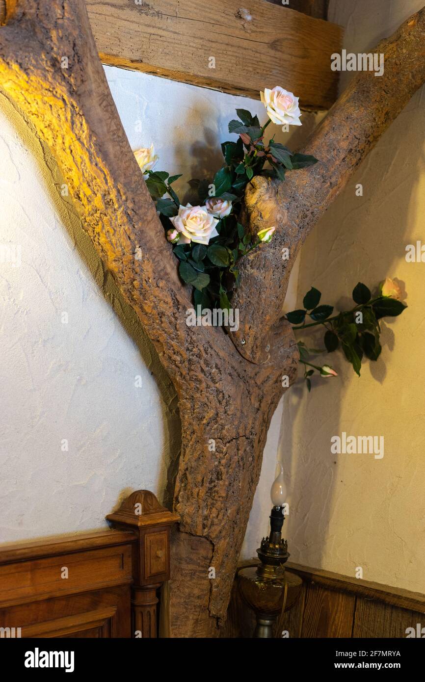 Tree trunk decoration with flowers in a wooden cottage Stock Photo - Alamy