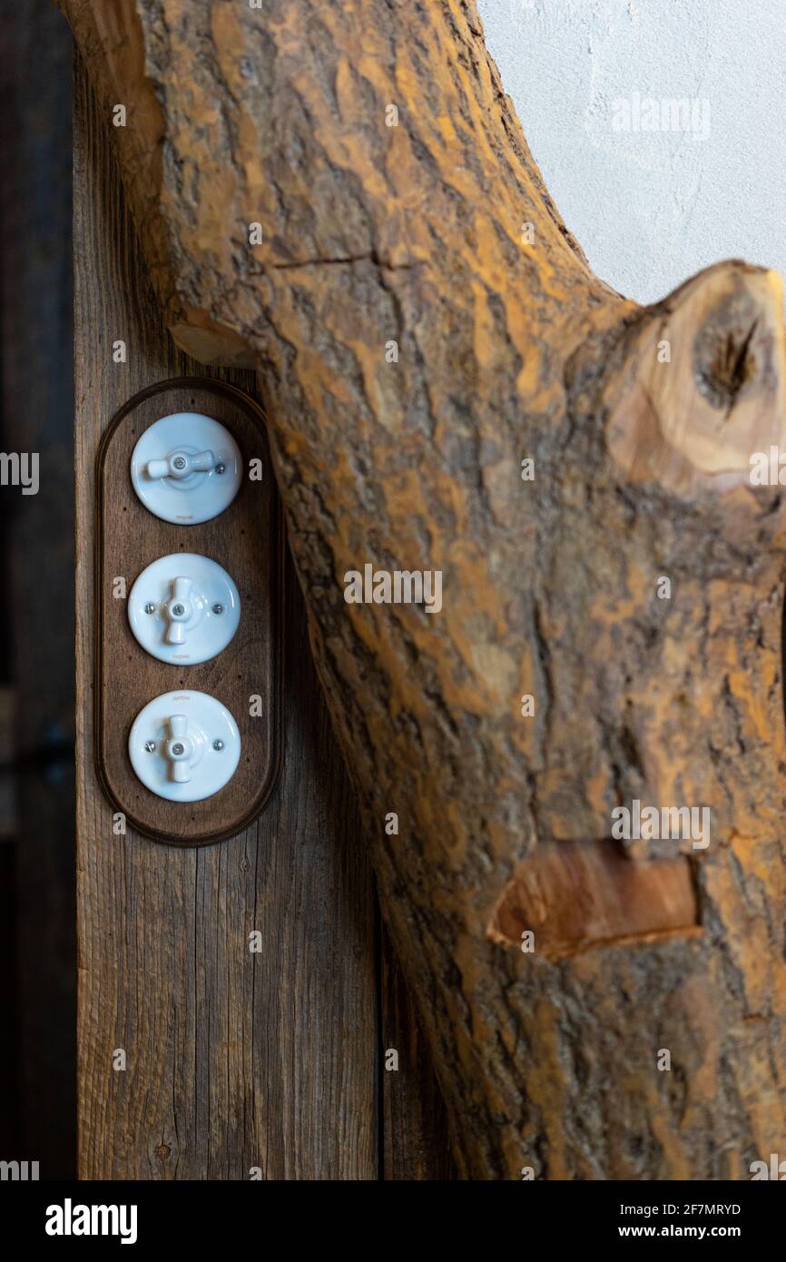 Three old light switches next to a decorative tree trunk Stock Photo ...
