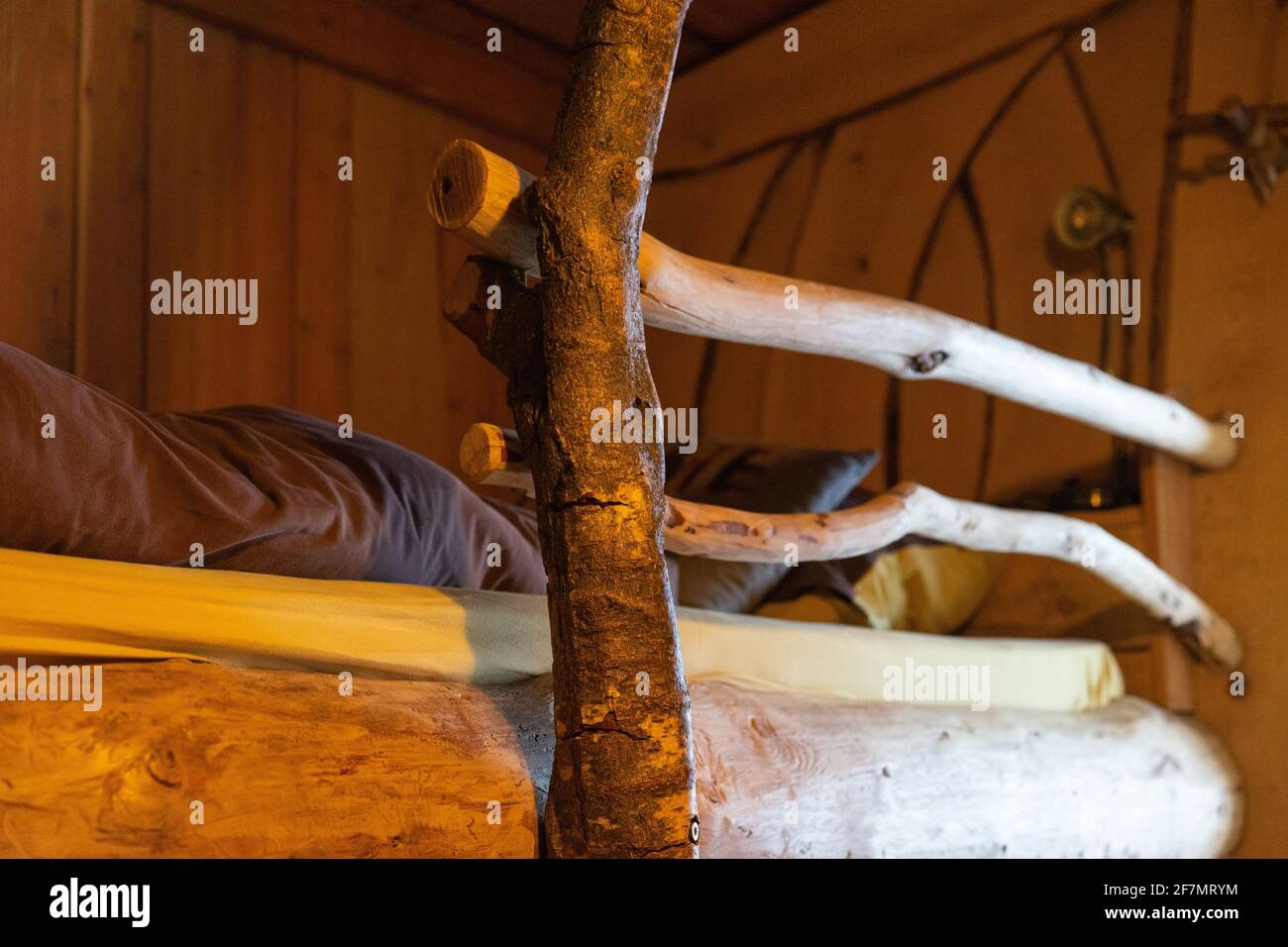 Bunk bed made with tree trunks Stock Photo - Alamy