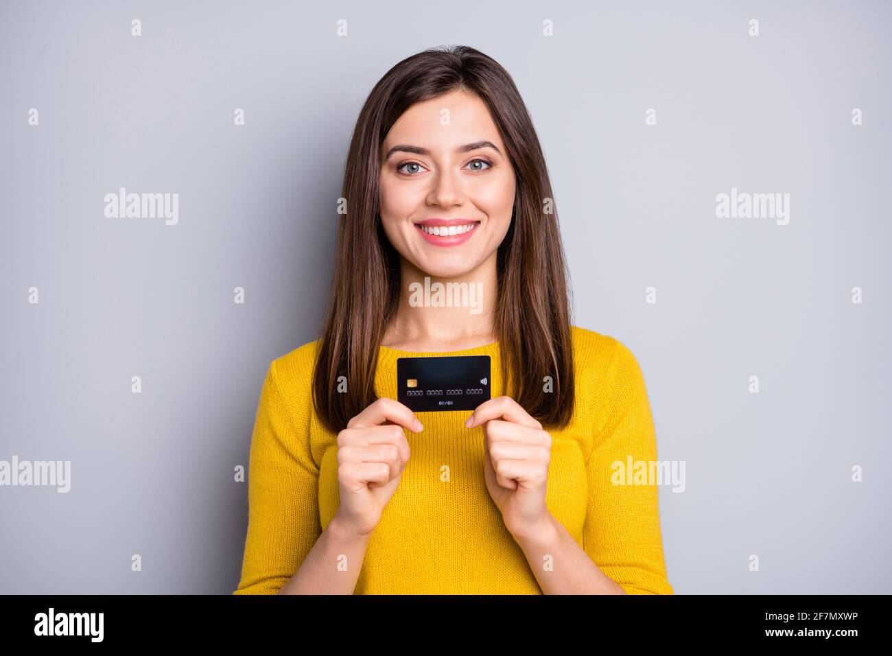 Photo of optimistic brunette nice lady hold card wear yellow sweater ...