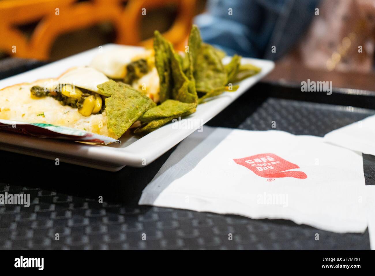 zoomed in focus shot showing the food tray wiht chips, doritos and ...