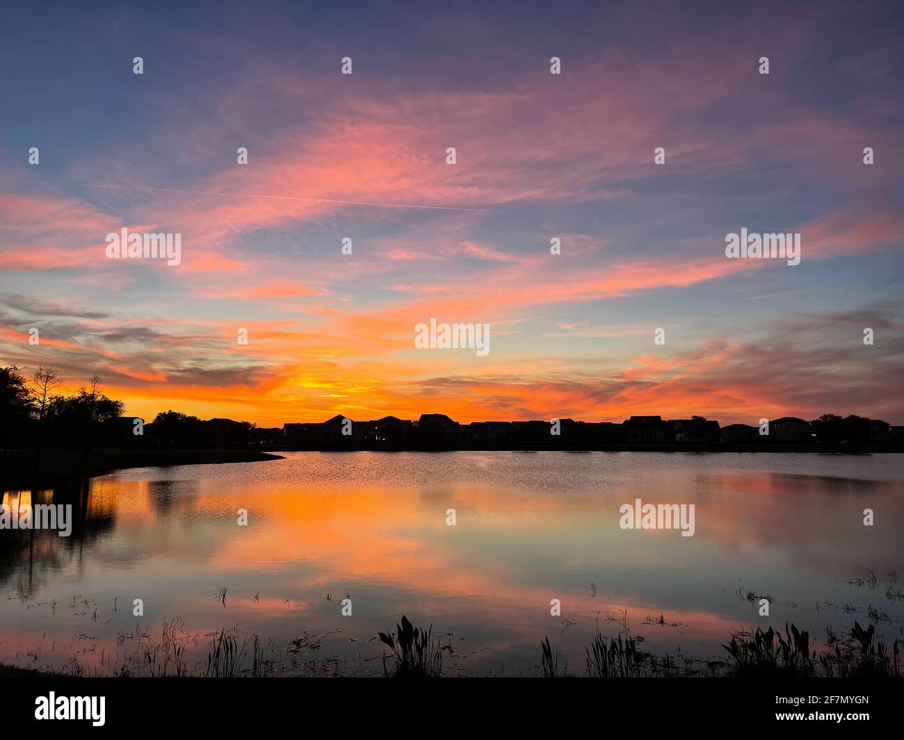 Beautiful pink, orange and blue sunset reflecting on a lake in a ...