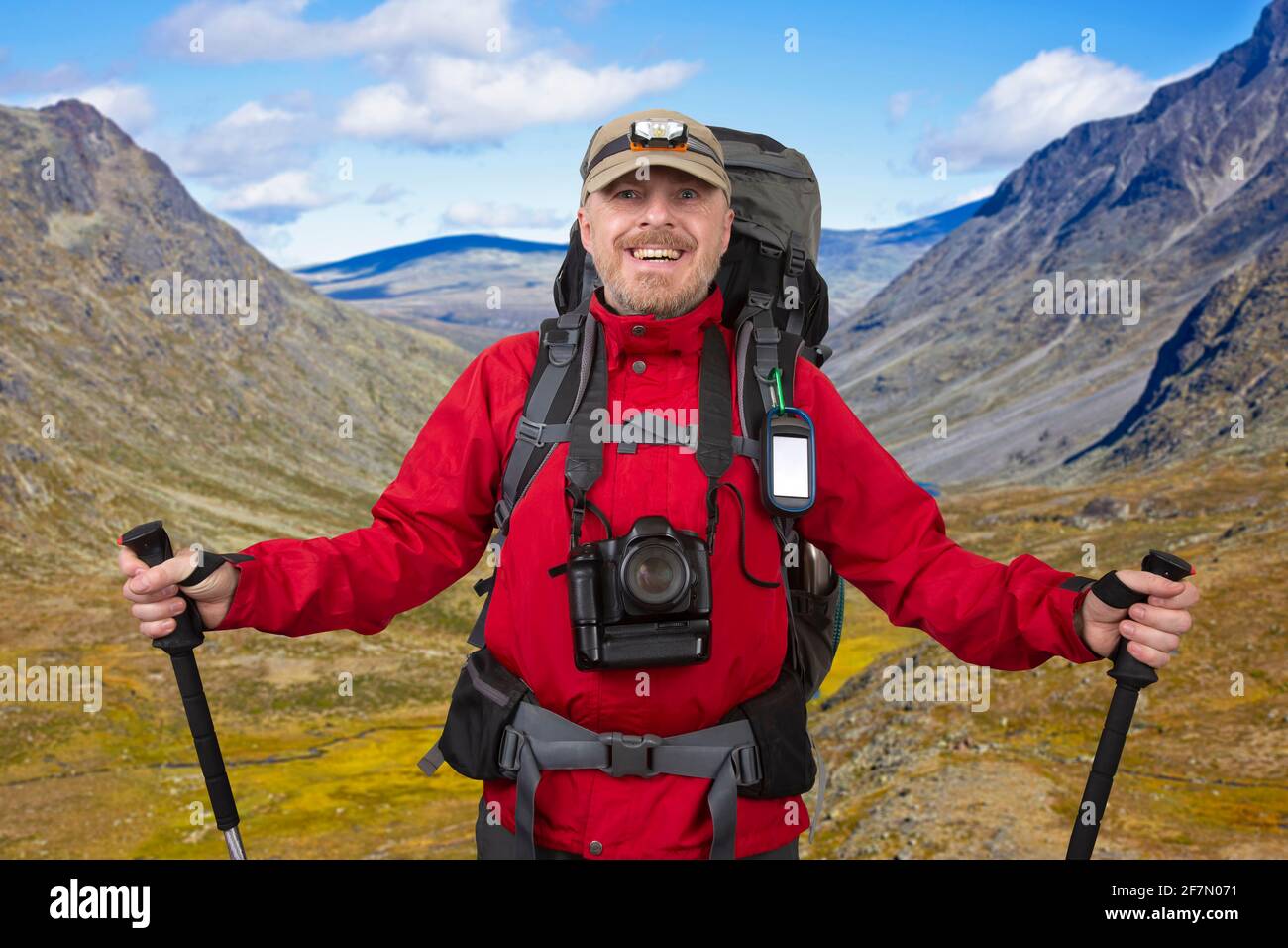 Happy bearded tourist with camera, Navigator and trekking poles on the ...