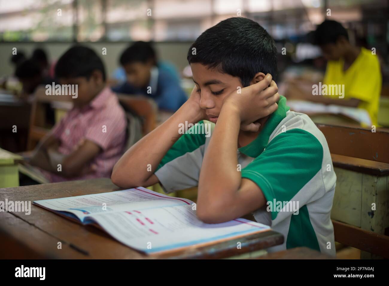 Varanasi, India. 10-14-2019. A child reading at a boarding school doing ...