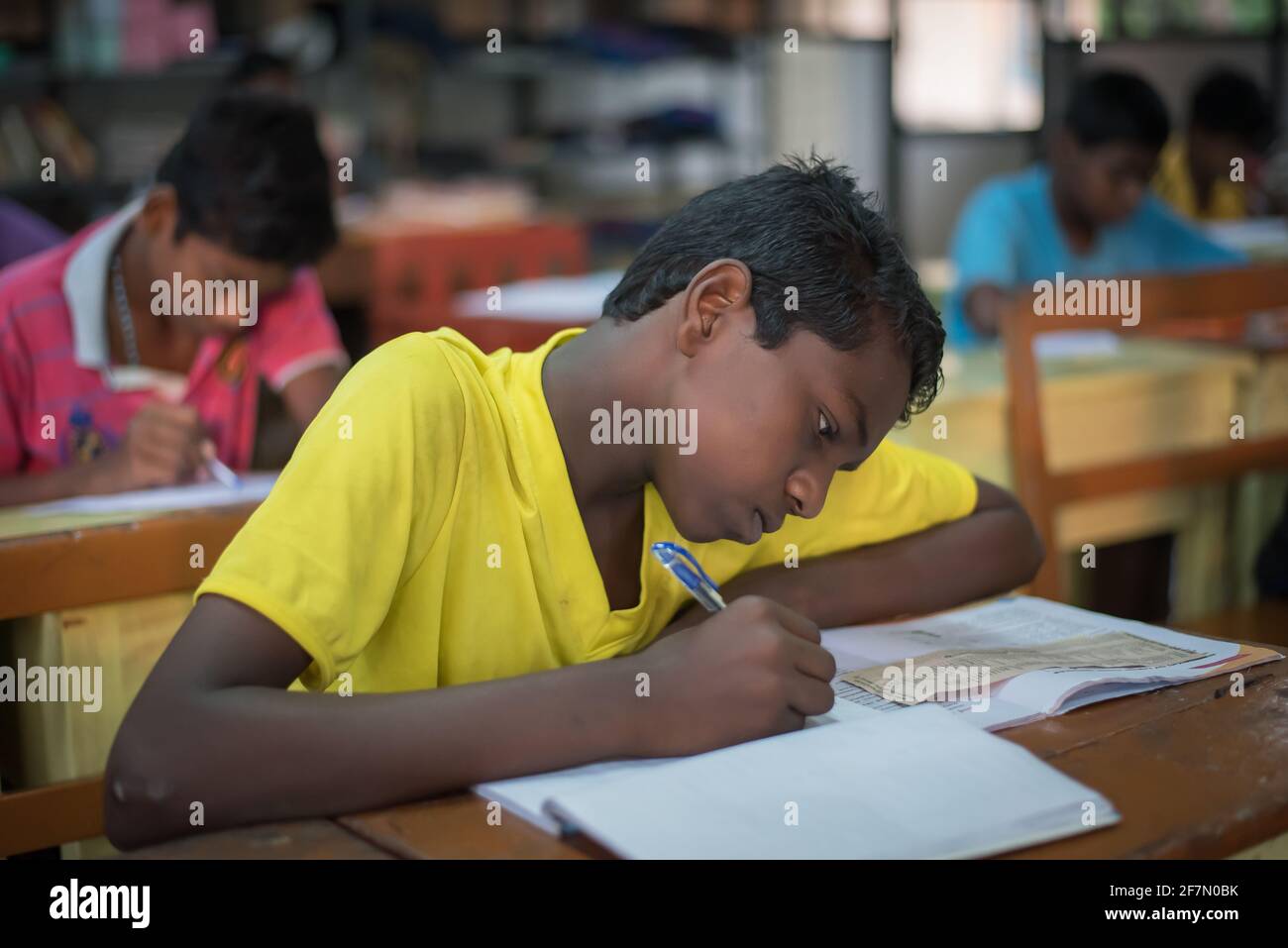 Varanasi, India. 10-14-2019. An male adolescent is writing in his ...