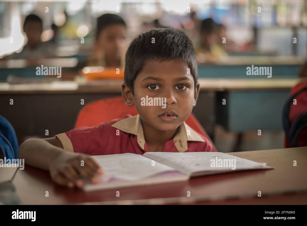 Varanasi, India. 10-14-2019. Portrait of a boy sitting on his bench ...