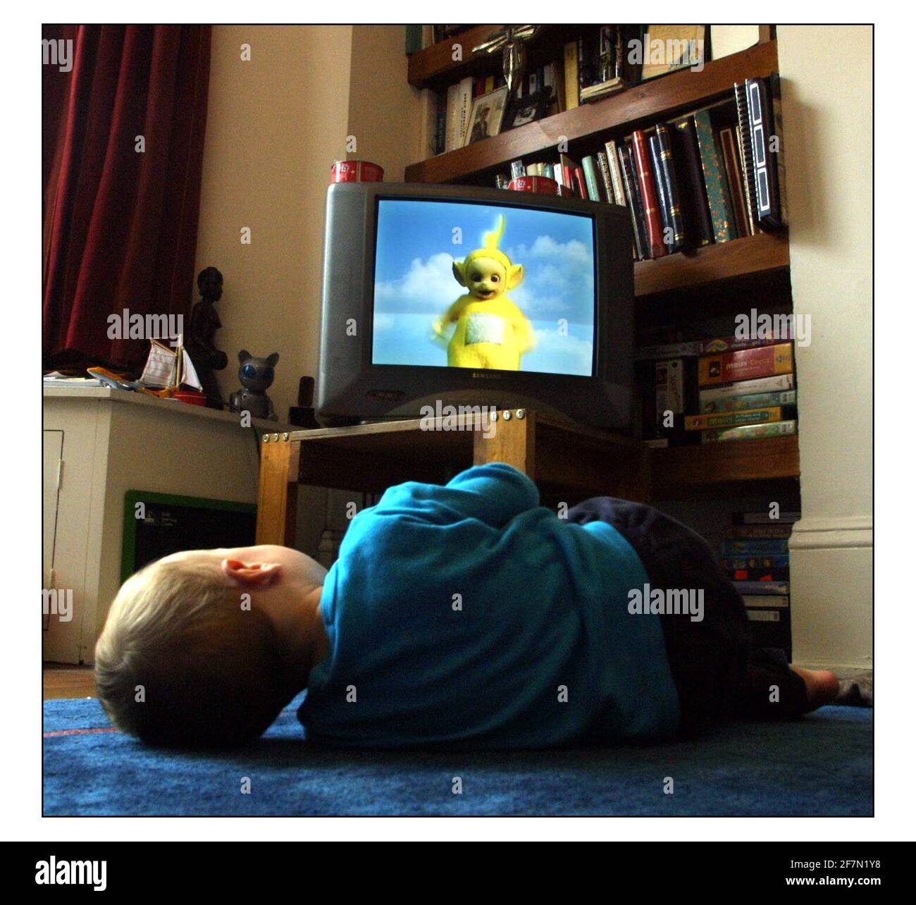 Oliver Bennett watching Tv with his son Bruno.pic David Sandison 30/10 ...