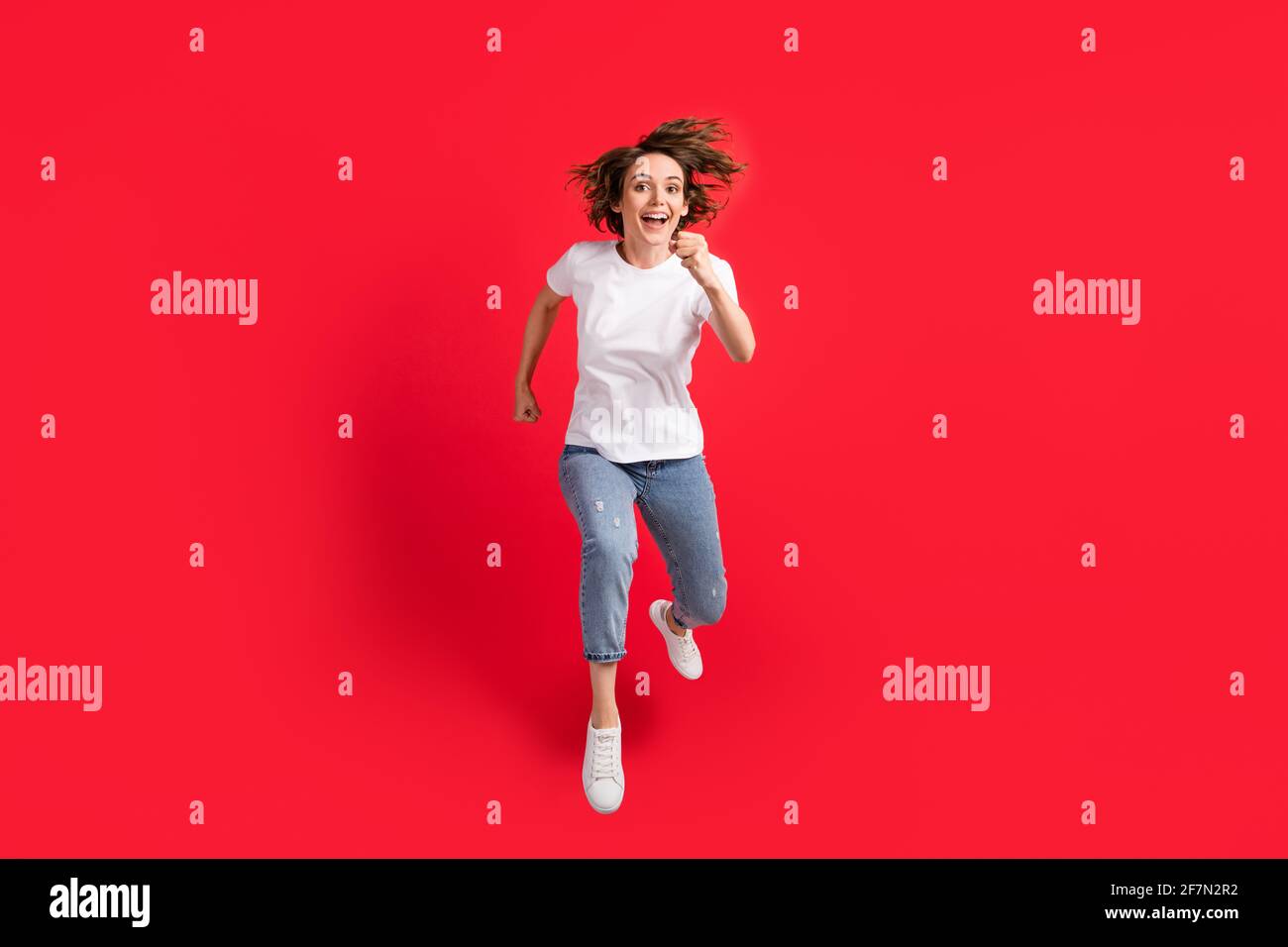 Full length body size view of attractive cheerful girl jumping running ...