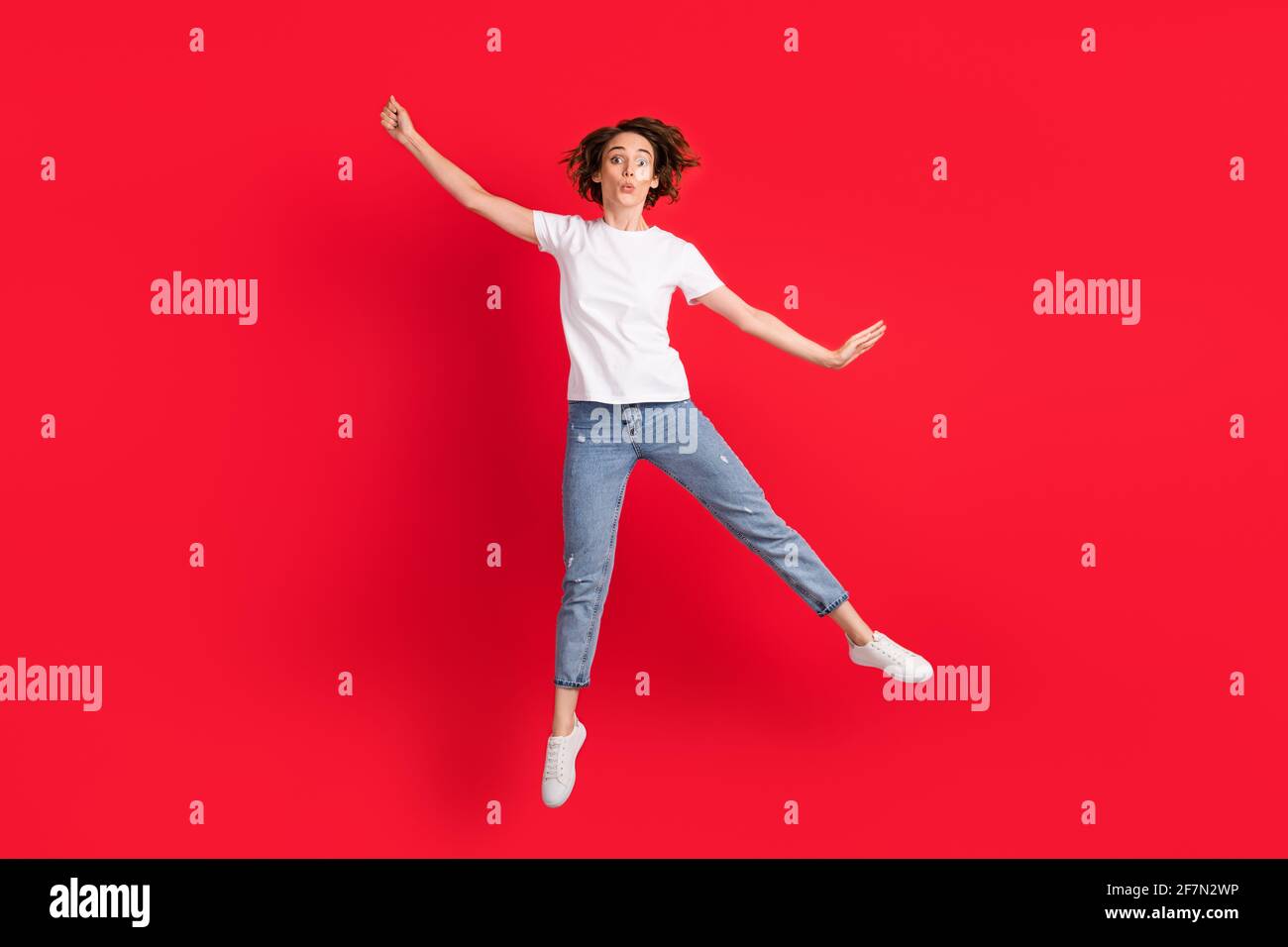 Full length body size view of nice funny skinny girl jumping having fun ...