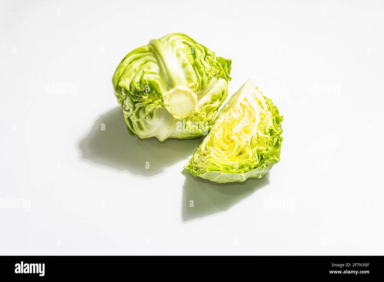 Fresh young cabbage, half and whole isolated on white background ...