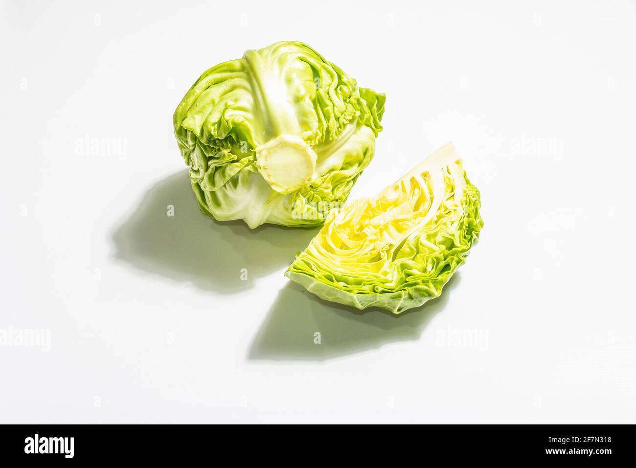 Fresh young cabbage, half and whole isolated on white background ...