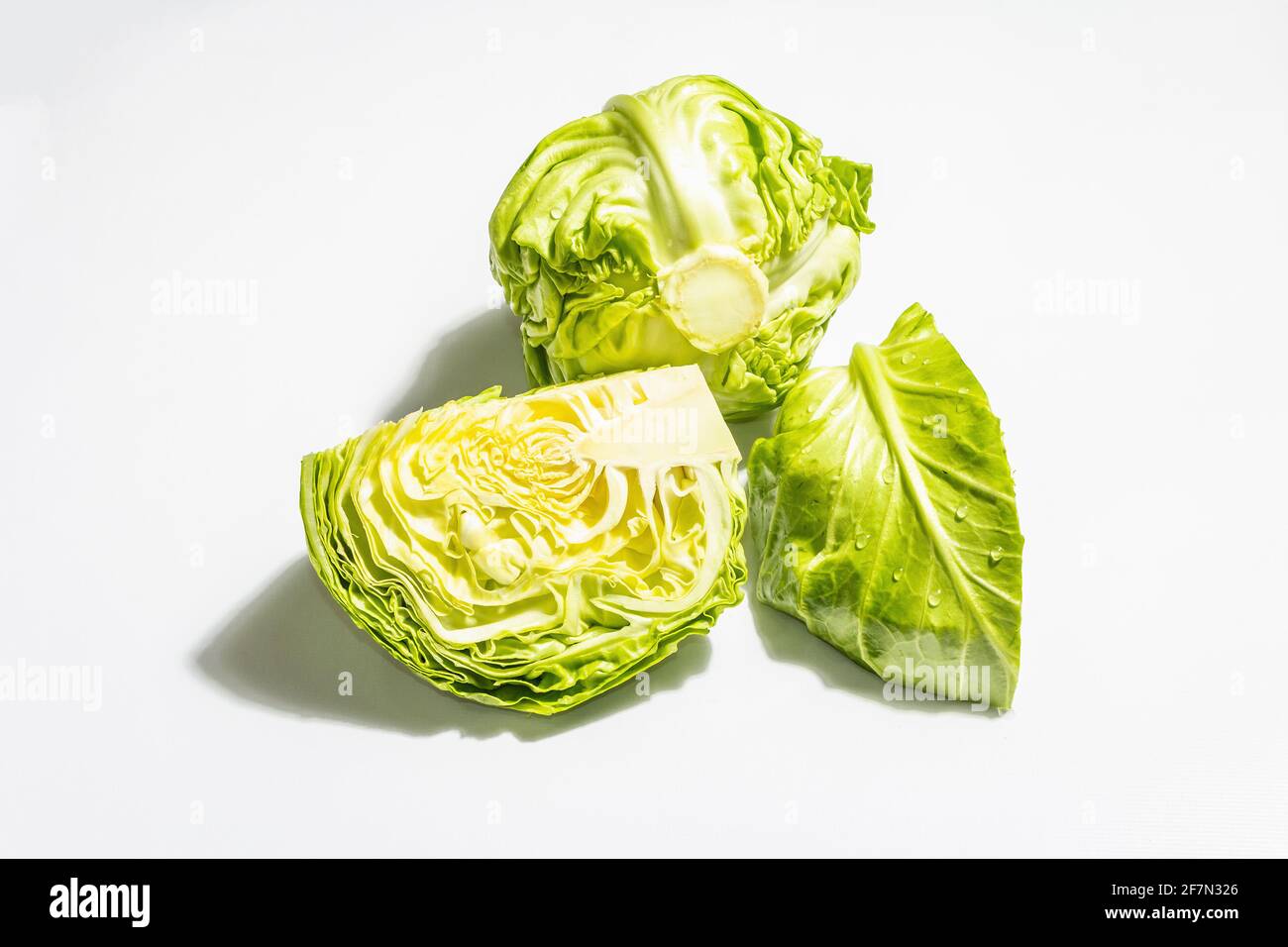 Fresh young cabbage, half and whole isolated on white background ...