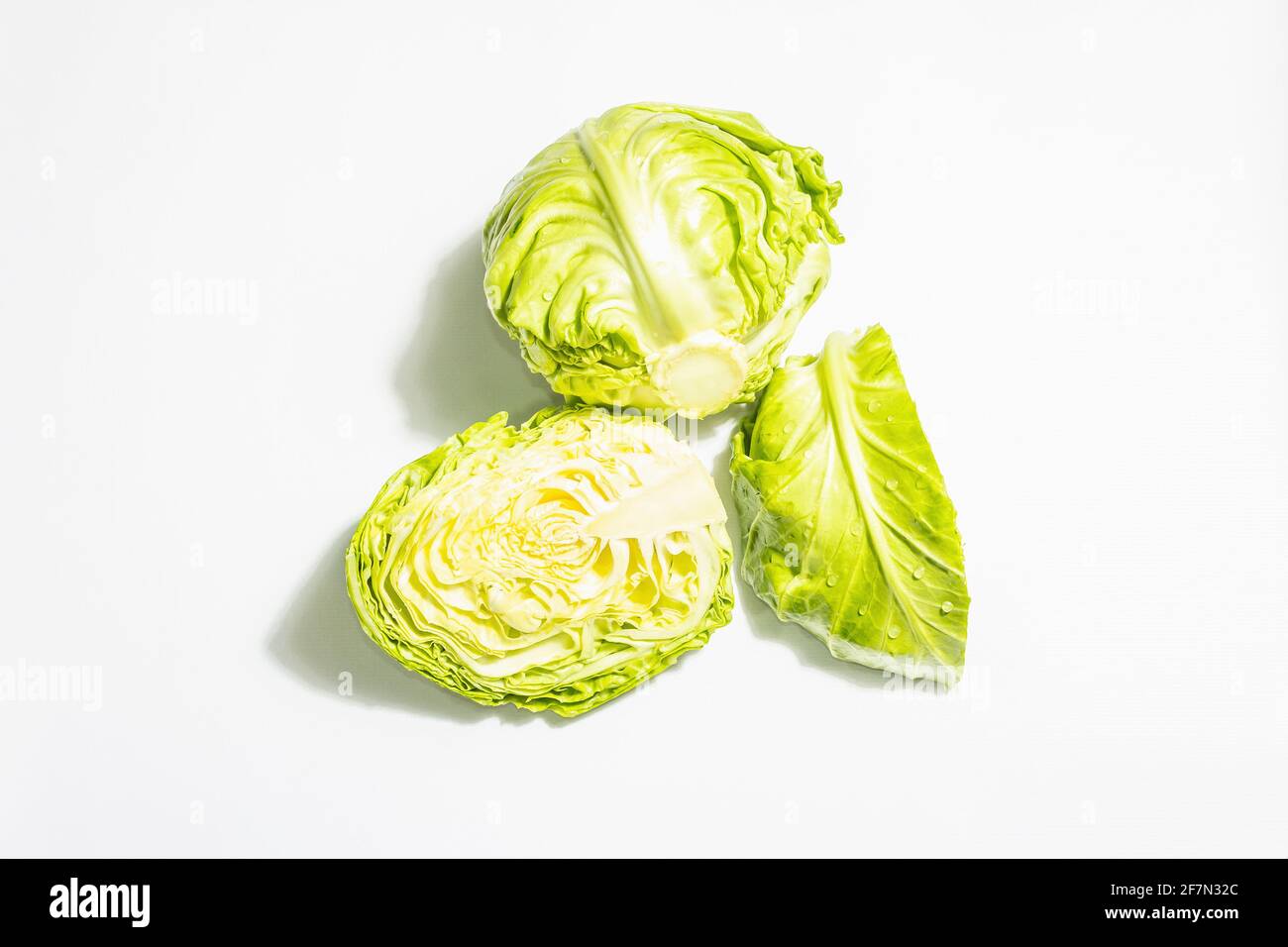 Fresh young cabbage, half and whole isolated on white background ...