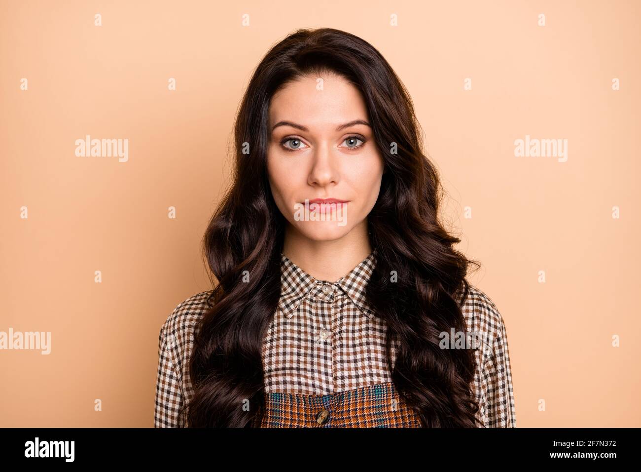 Portrait of pretty calm content wavy-haired girl wearing checked ...