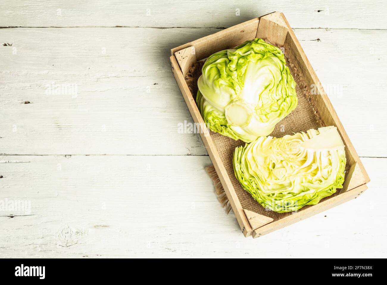 Fresh young cabbage. Wooden crate, old white boards background Stock ...