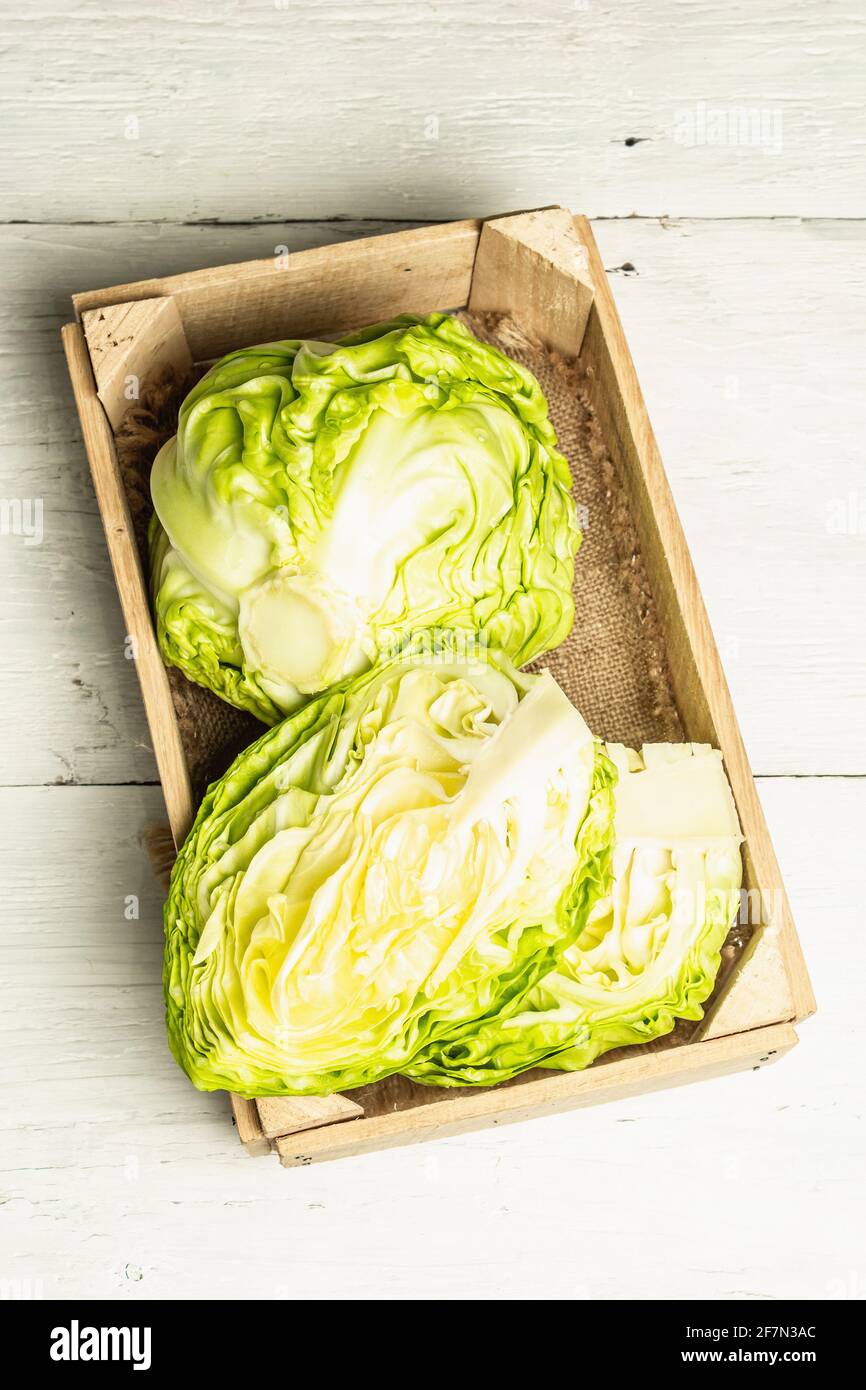 Fresh young cabbage. Wooden crate, old white boards background Stock ...