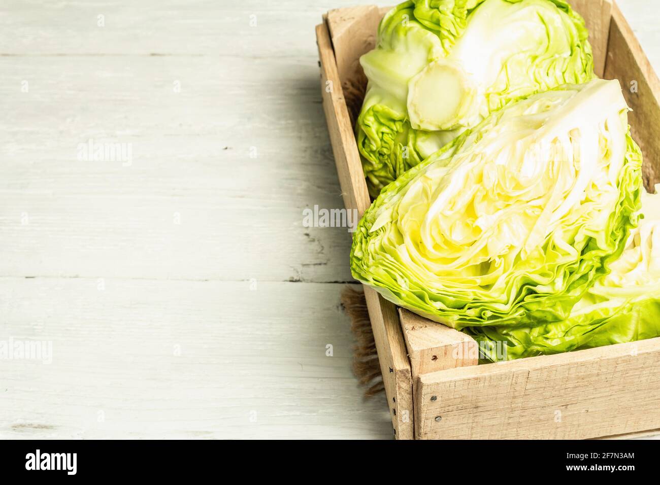 Fresh young cabbage. Wooden crate, old white boards background Stock ...