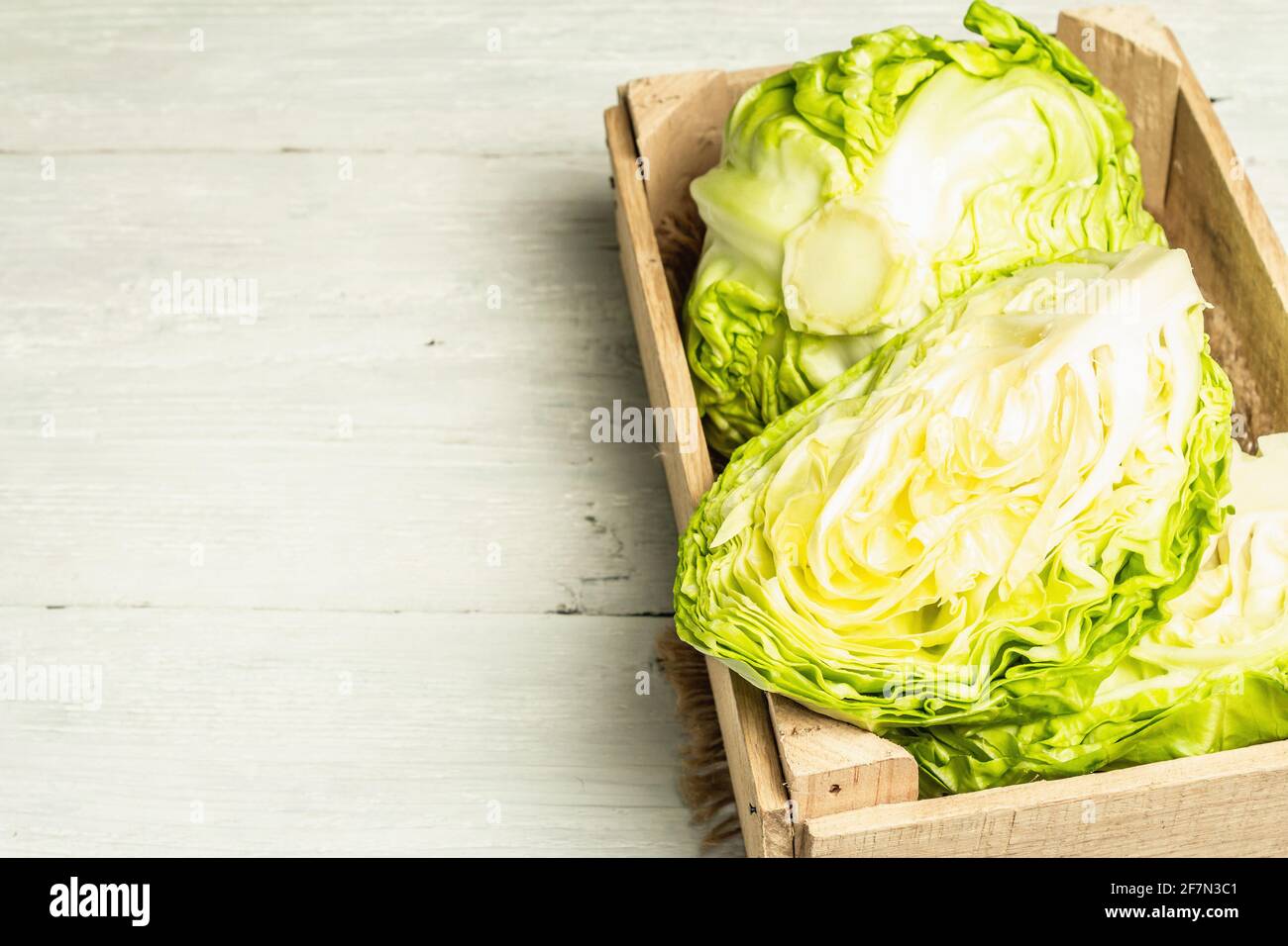 Fresh young cabbage. Wooden crate, old white boards background Stock ...