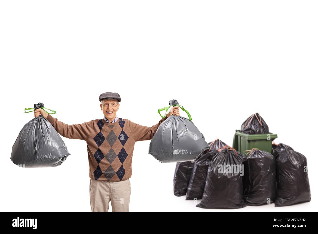 Elderly man with garbage bags in front of a waste bin isolated on white ...