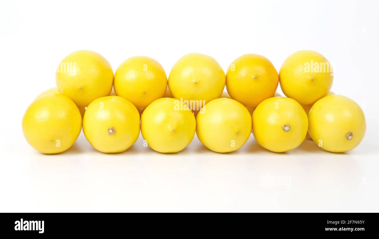 pyramid of whole lemons on a white background Stock Photo - Alamy