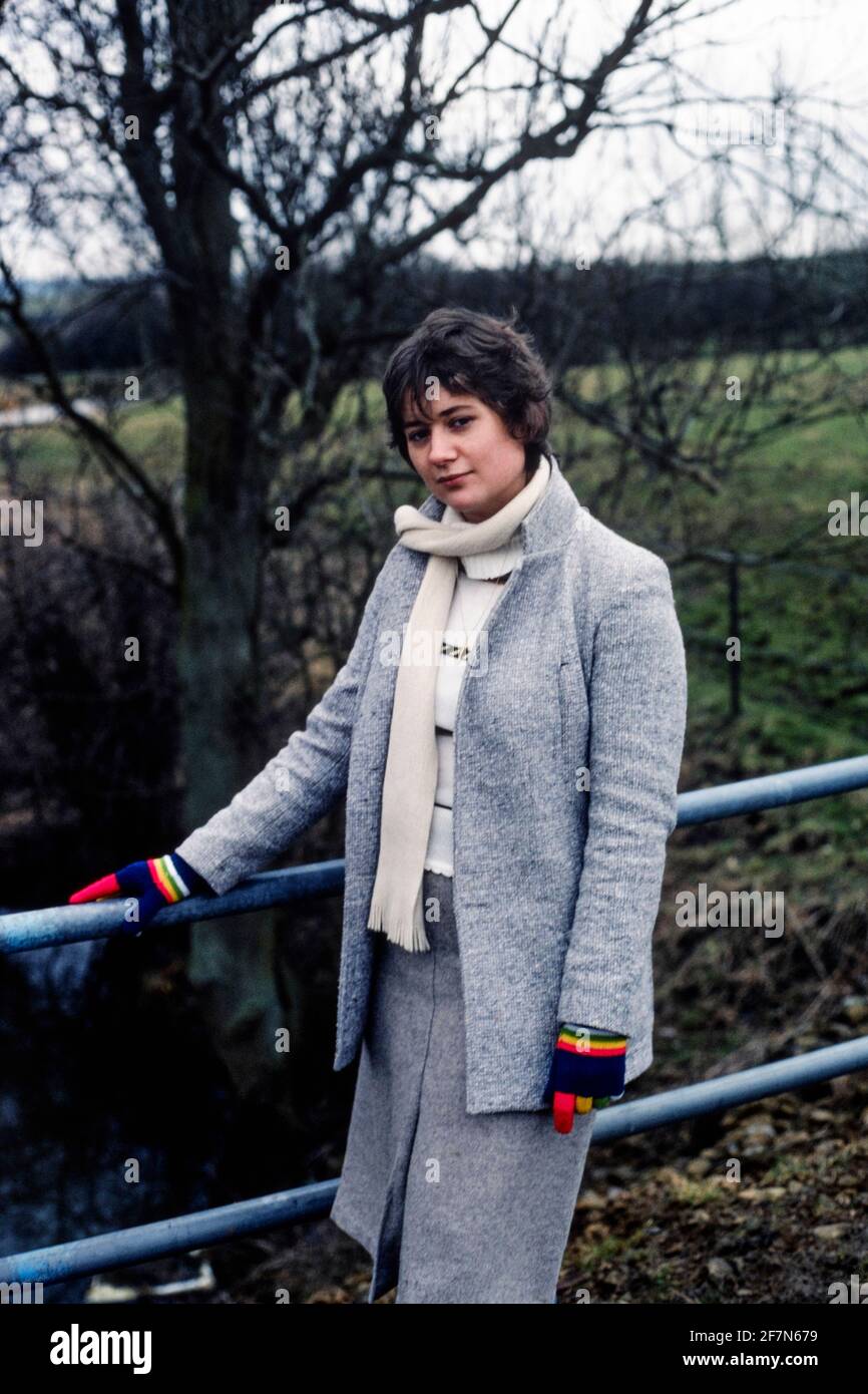 young pretty woman smartly dressed in fashionable clothes of the time ...