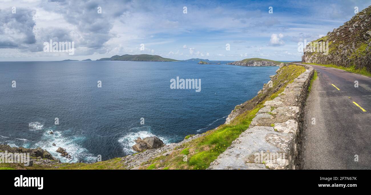 Large panorama with narrow winding road on the edge of cliff with ...