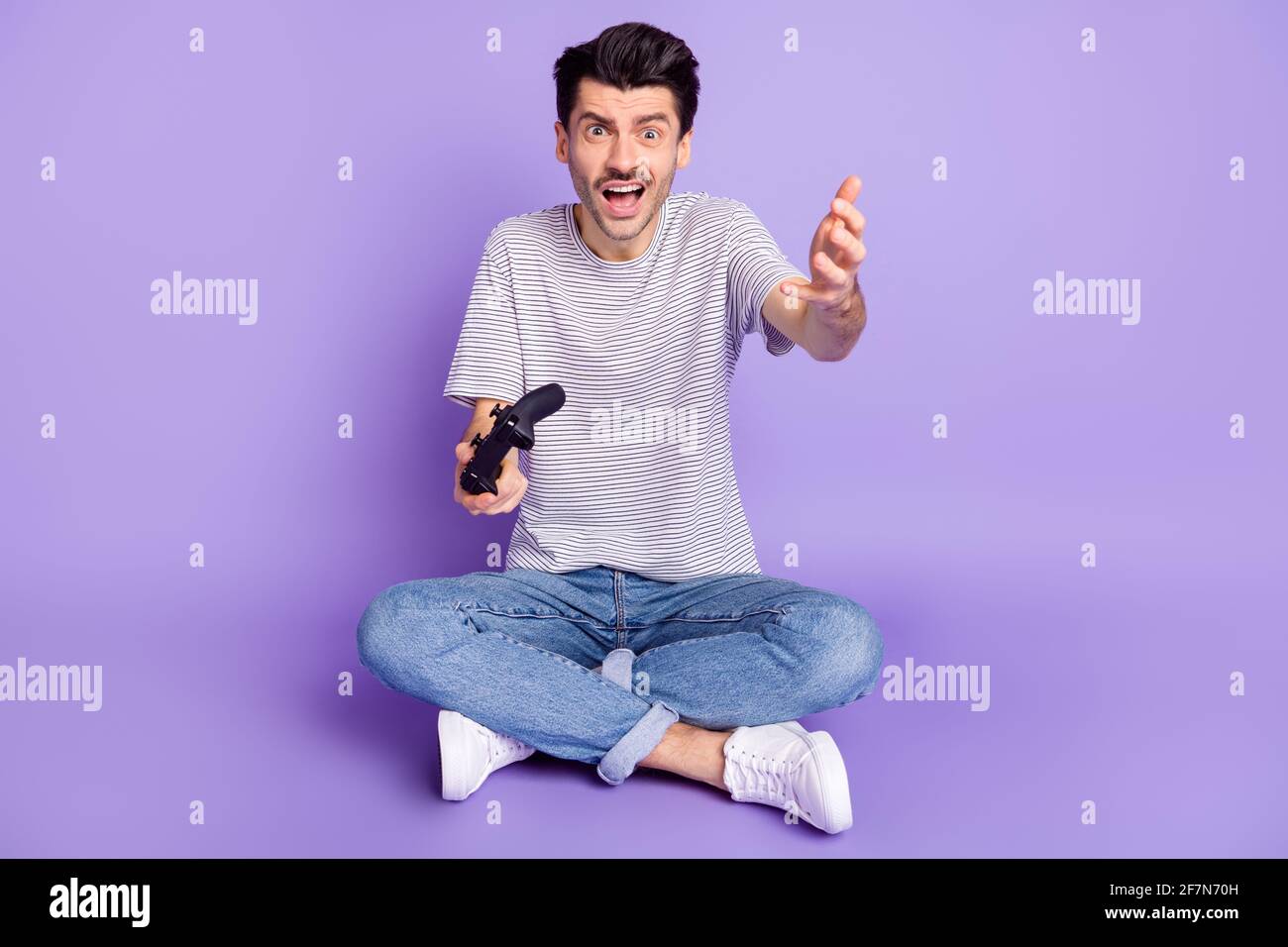 Photo of guy hold controller open mouth raise hand wear striped t-shirt ...