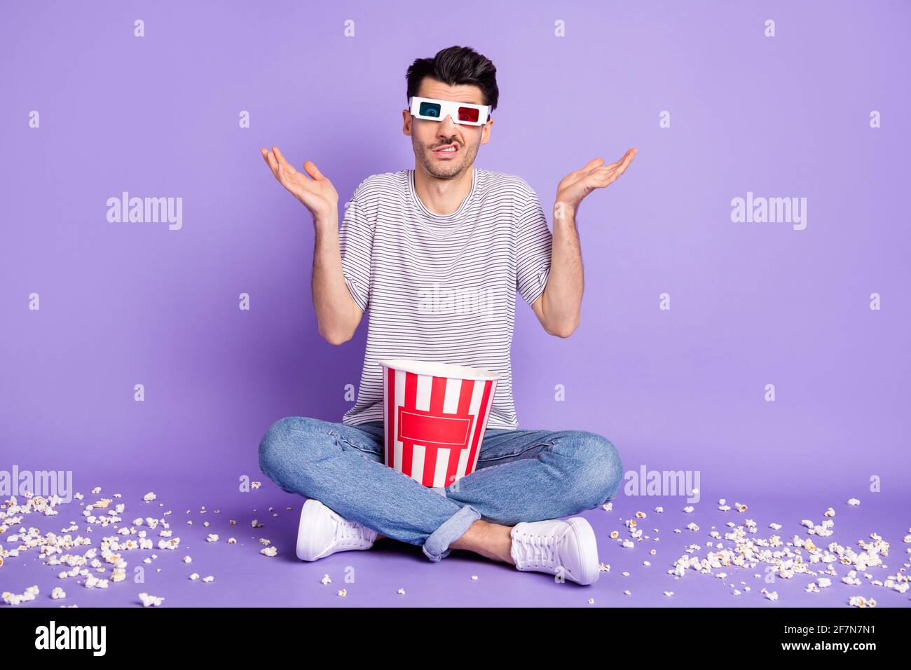 Photo of man hold box popcorn dirty floor shrug wear 3d specs white t ...