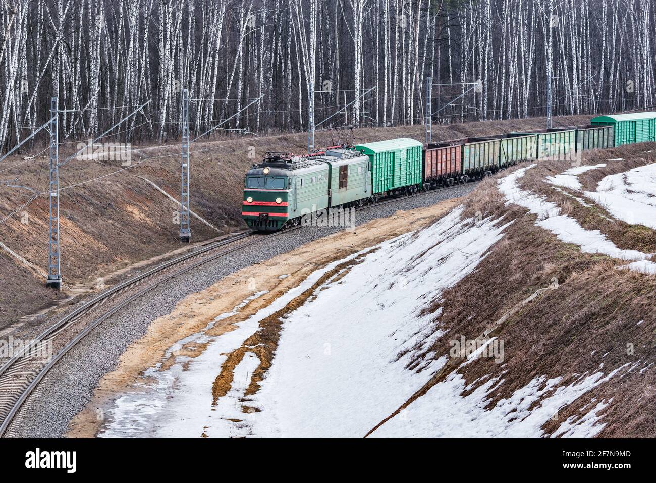 Long freight train approaches to the station Stock Photo - Alamy