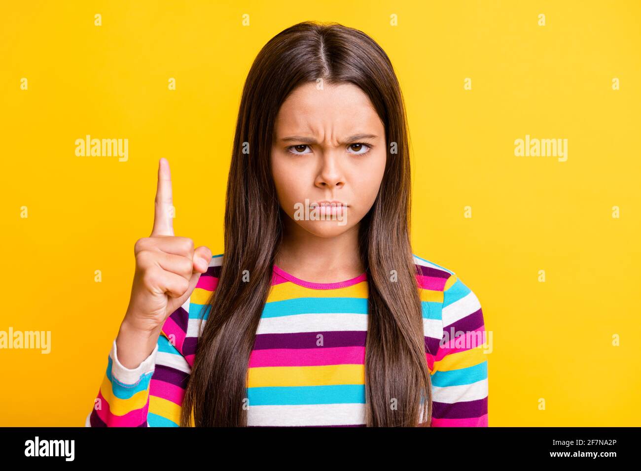 Photo of strict small girl frowning look camera raise direct finger up ...