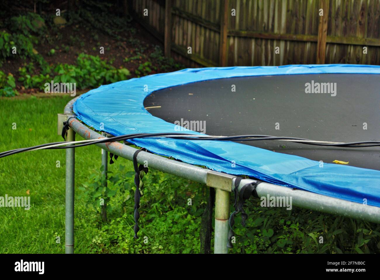 Dangerous live downed power line draped across trampoline Stock Photo ...
