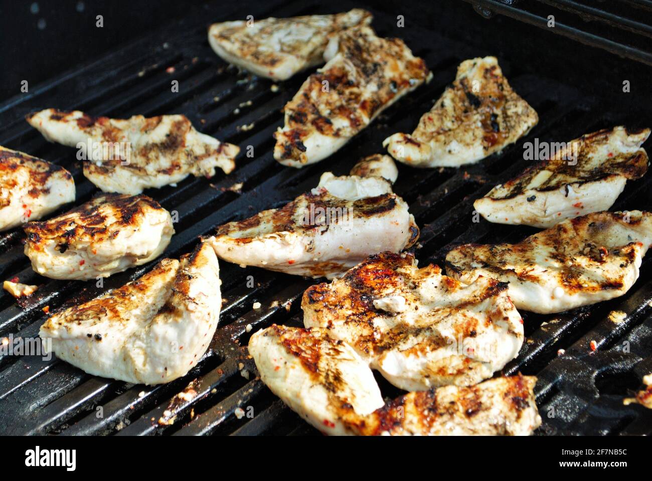 Cooking chicken on the grill for a backyard barbecue Stock Photo - Alamy