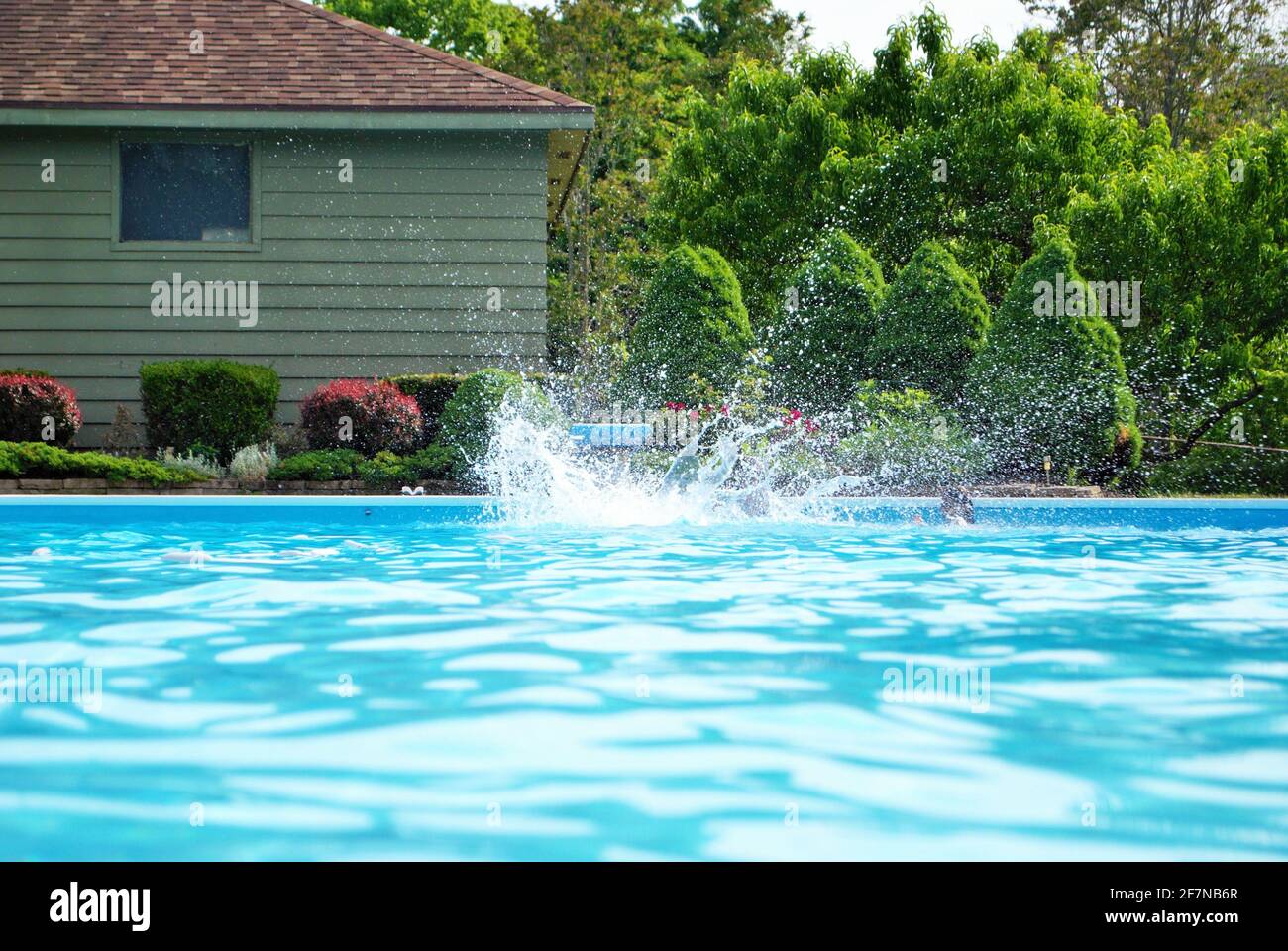 Big splash after someone jumped off the diving board Stock Photo - Alamy