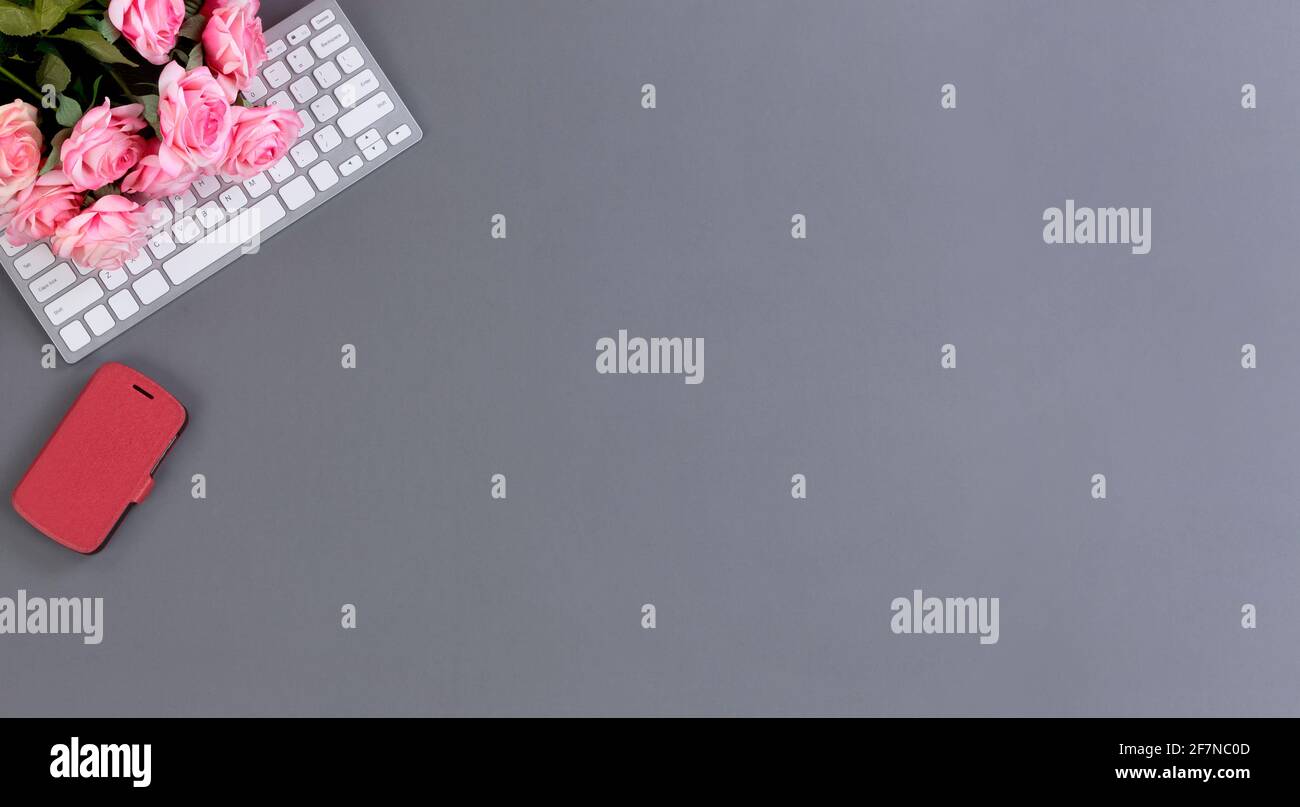 Desktop workspace with computer keyboard, smartphone and lovely pink ...