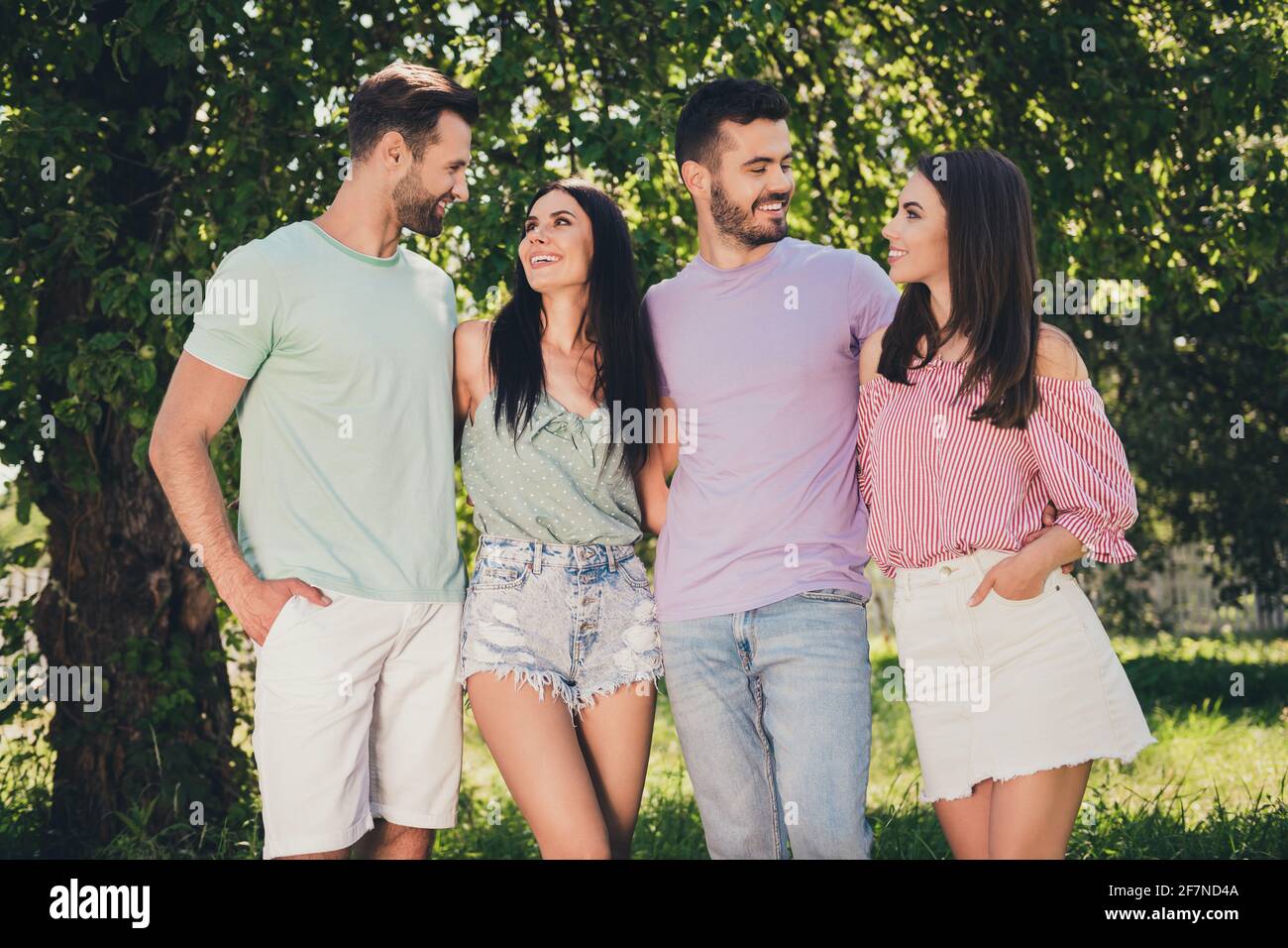 Photo of lovely four friends couples look at each other good mood smile ...