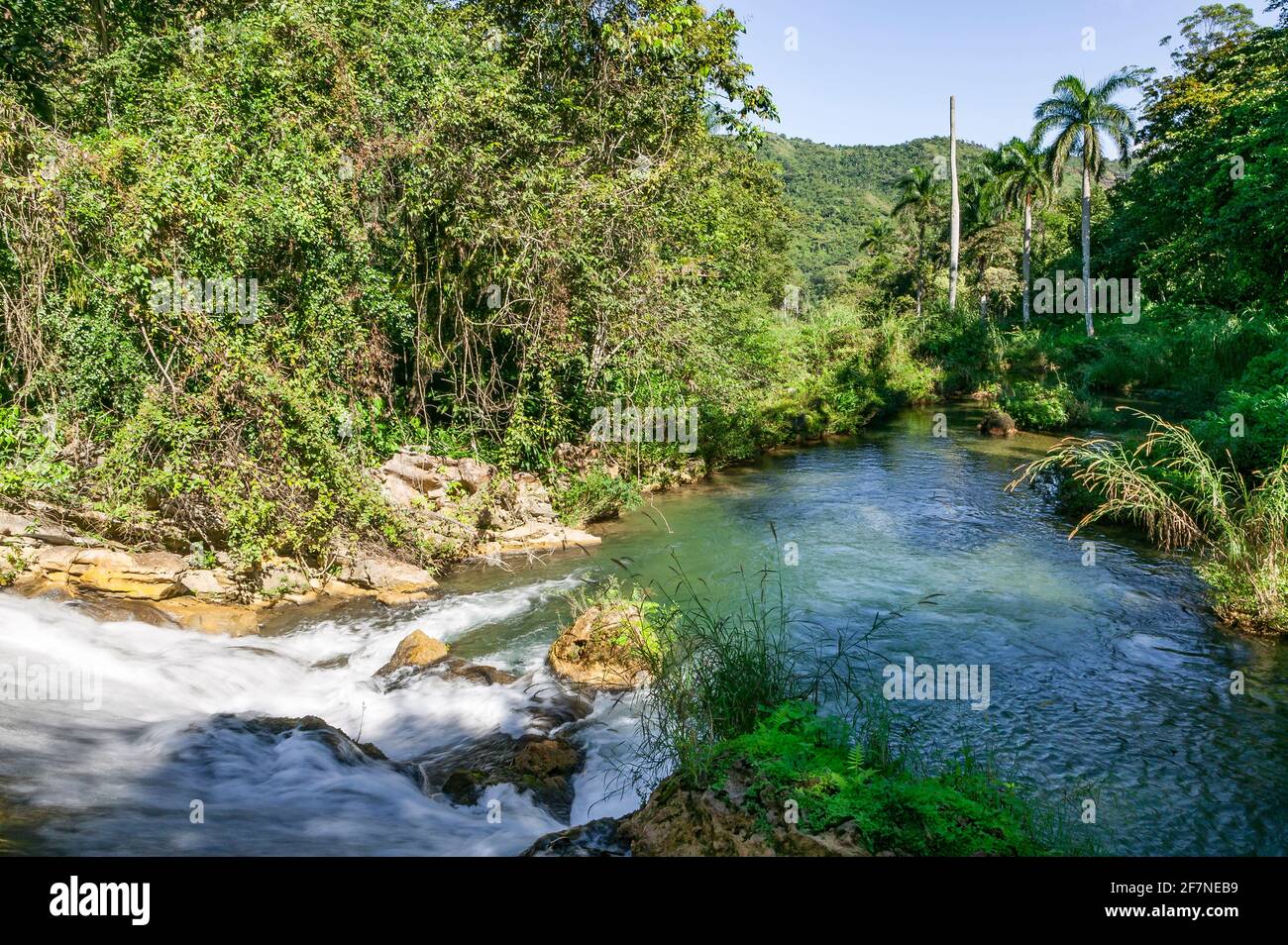 The rushing water of the El Nicho lower falls form a pristine natural ...