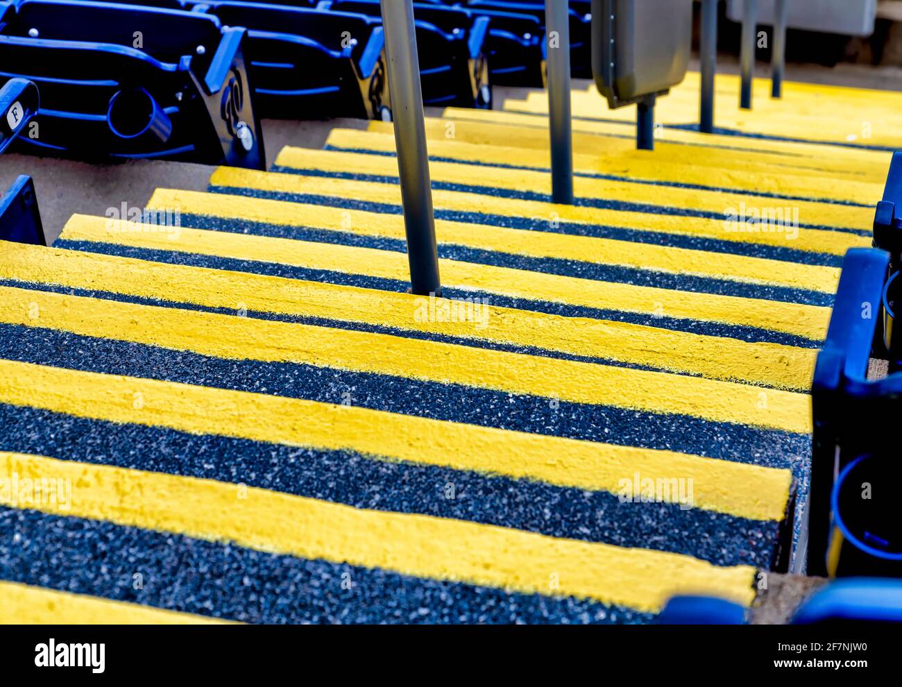 Yellow painted steps leading to stadium seating Stock Photo - Alamy