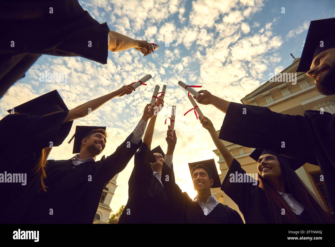Graduates raise up diplomas hi-res stock photography and images - Alamy