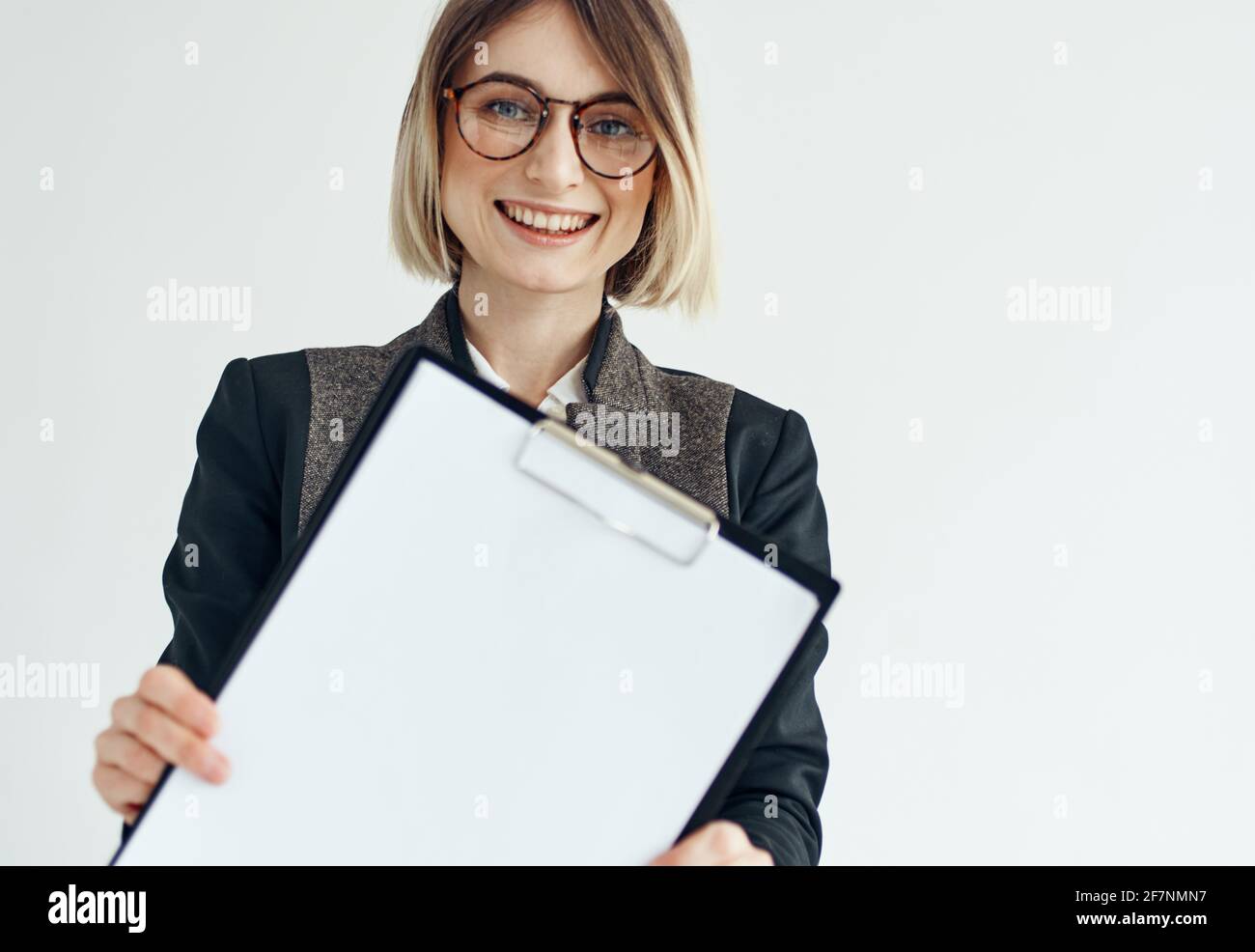 Business woman in a jacket manager model glasses and a white sheet of ...