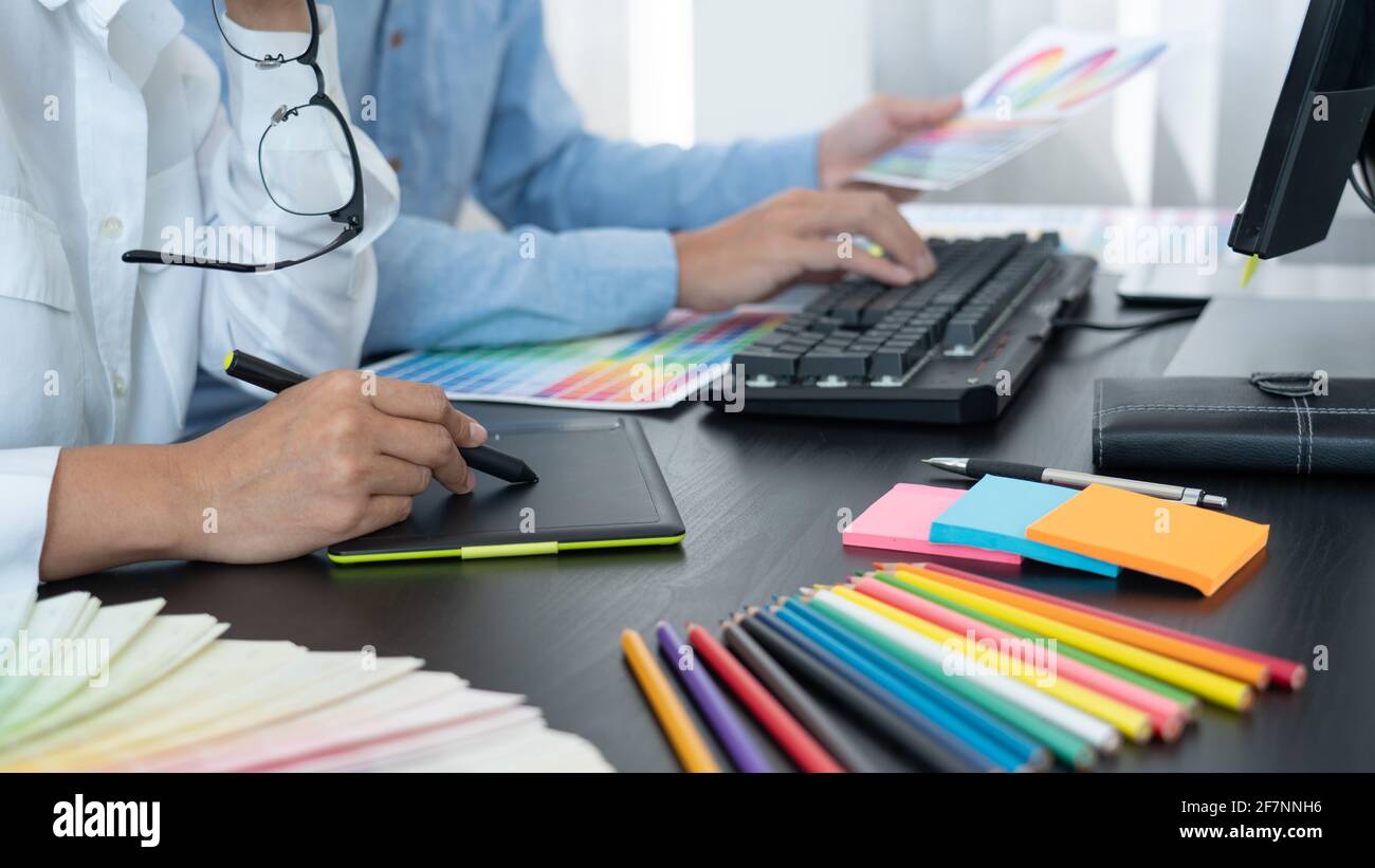 Graphic designer or creative working together coloring using graphics ...