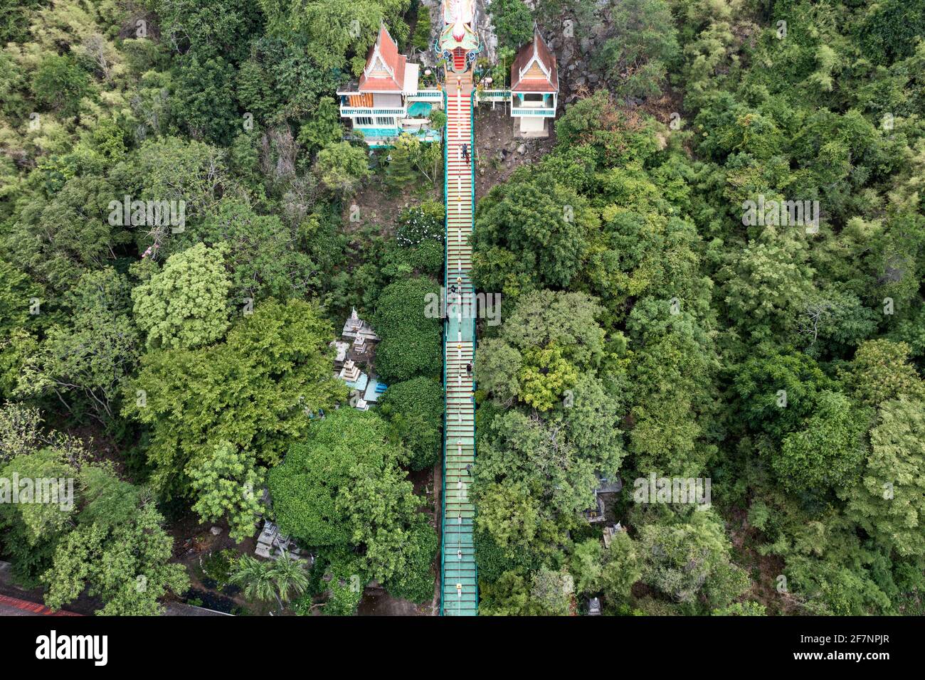 Top view of Tourists walking on long stair up to the temple in tropical ...