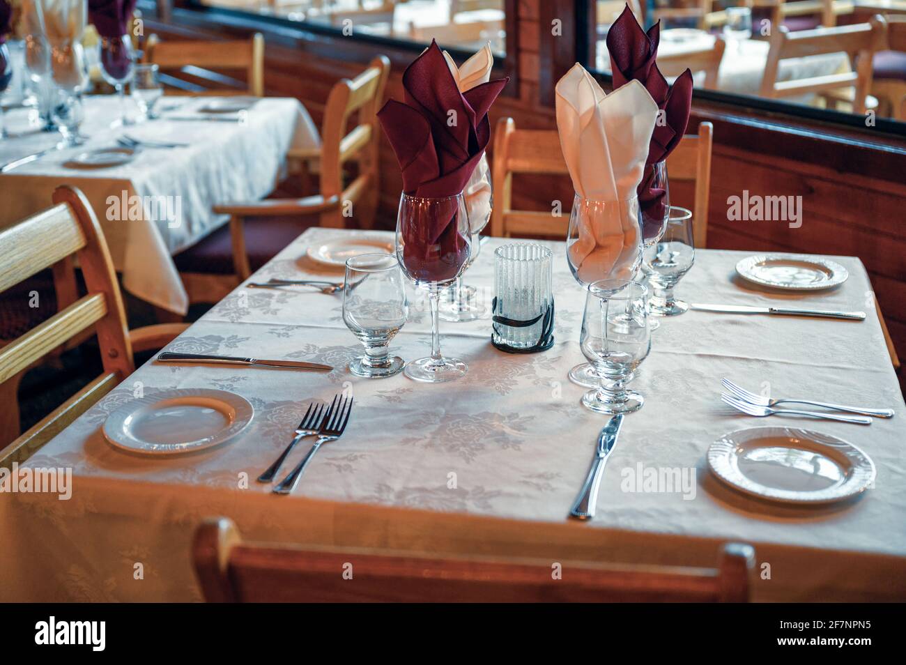 Rustic wooden dining table with tableware and glass in restaurant Stock ...