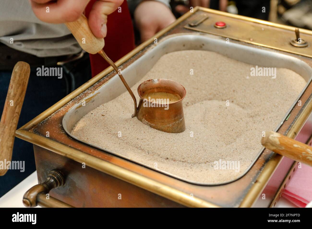 Oriental coffee or Turkish coffee. Coffee turk, hot sand, hands Stock ...