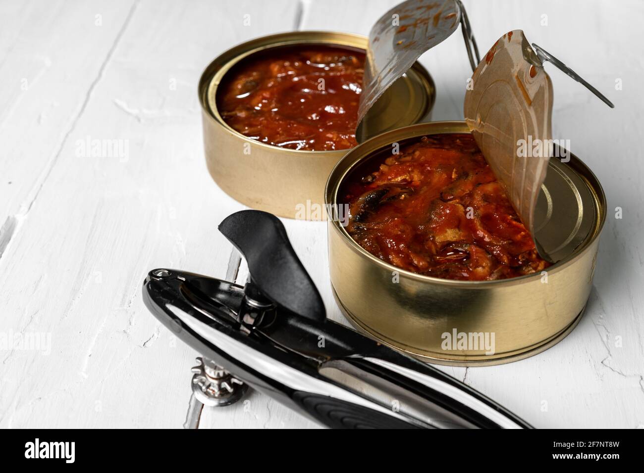 Fish tin can on white wooden background Stock Photo - Alamy