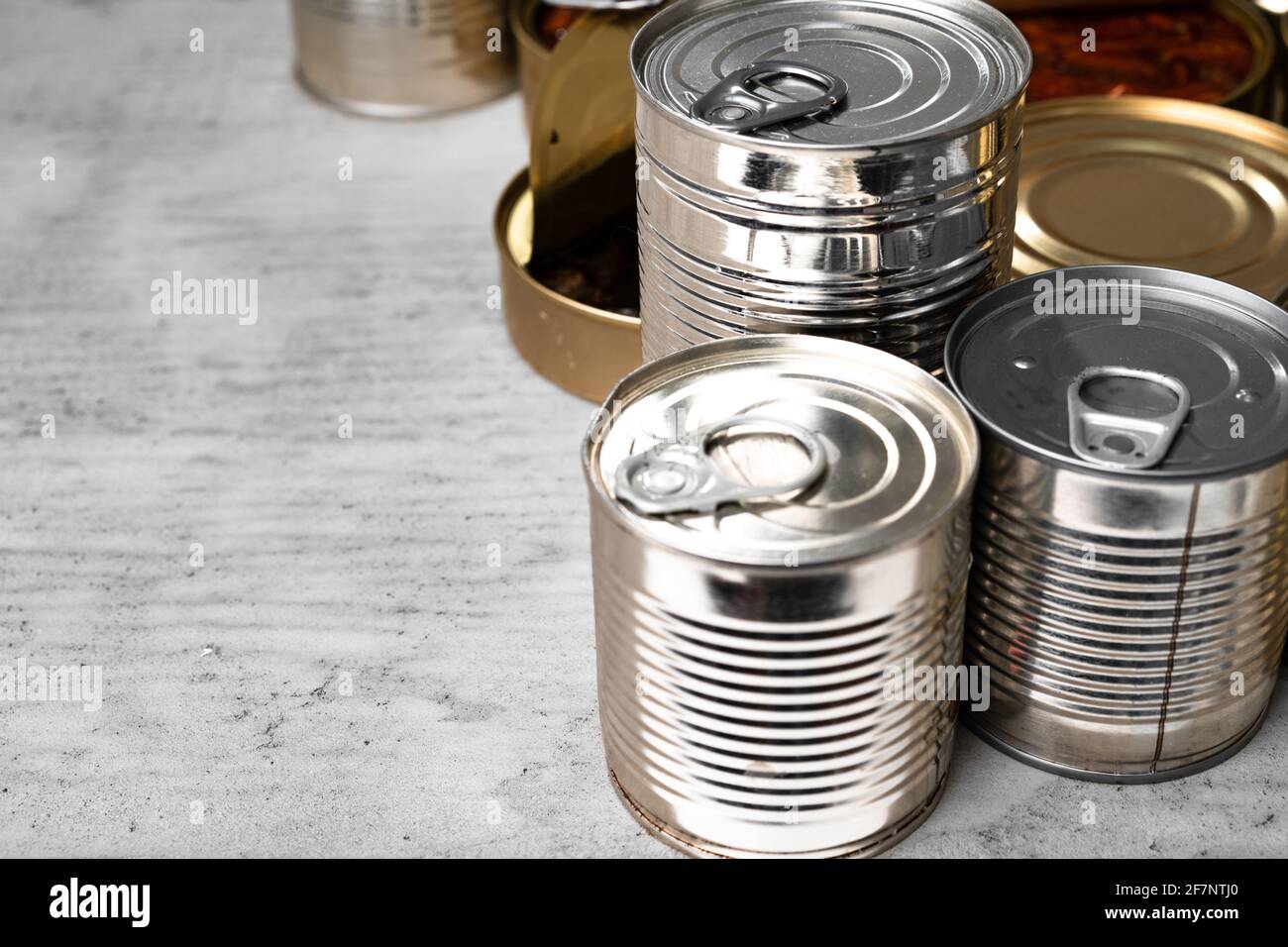 Tin cans with conserved food on gray surface Stock Photo - Alamy