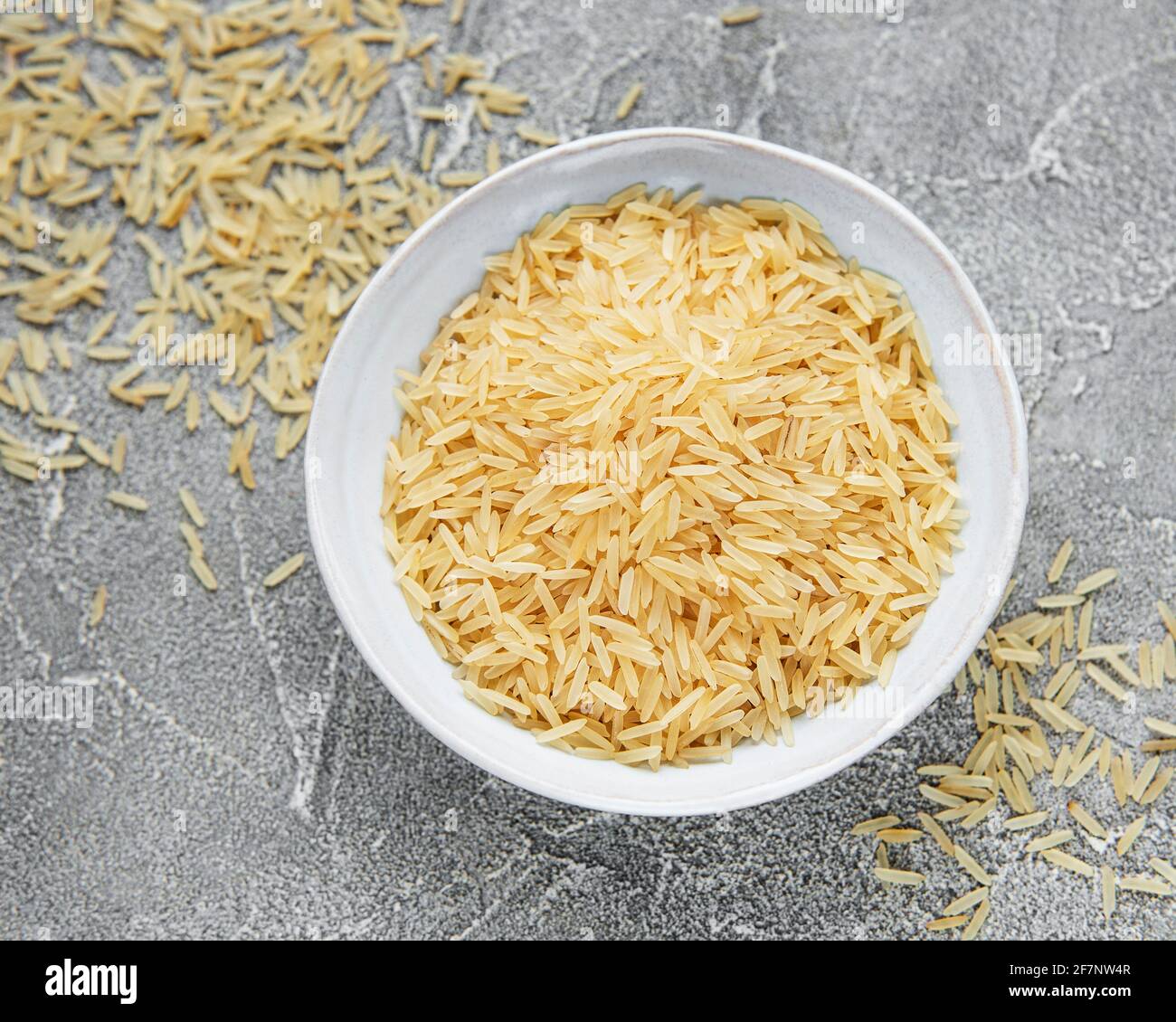 Uncooked basmati rice on a grey concrete background Stock Photo - Alamy