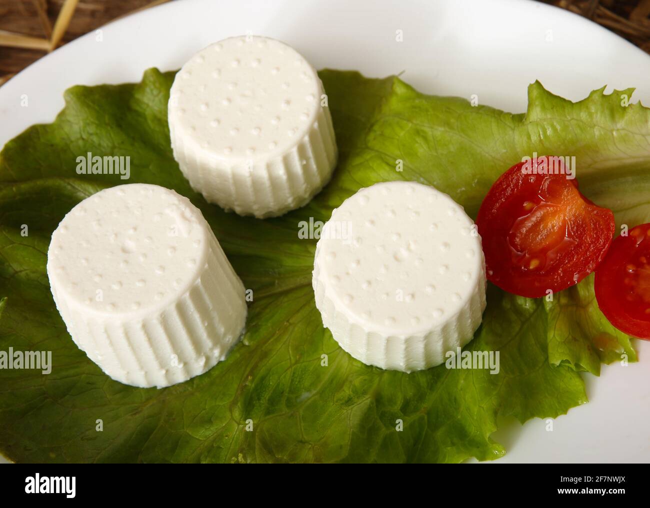 Italian cheese - goat's milk ricotta placed on a sheet of salad leaves ...
