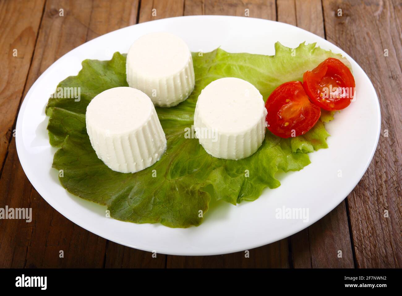 Italian cheese - goat's milk ricotta placed on a sheet of salad leaves ...