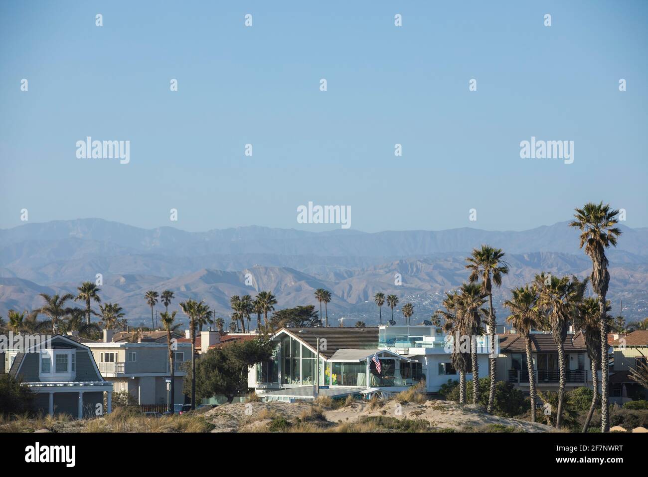 Sunset view of coastal dunes and houses in Oxnard, California, USA ...
