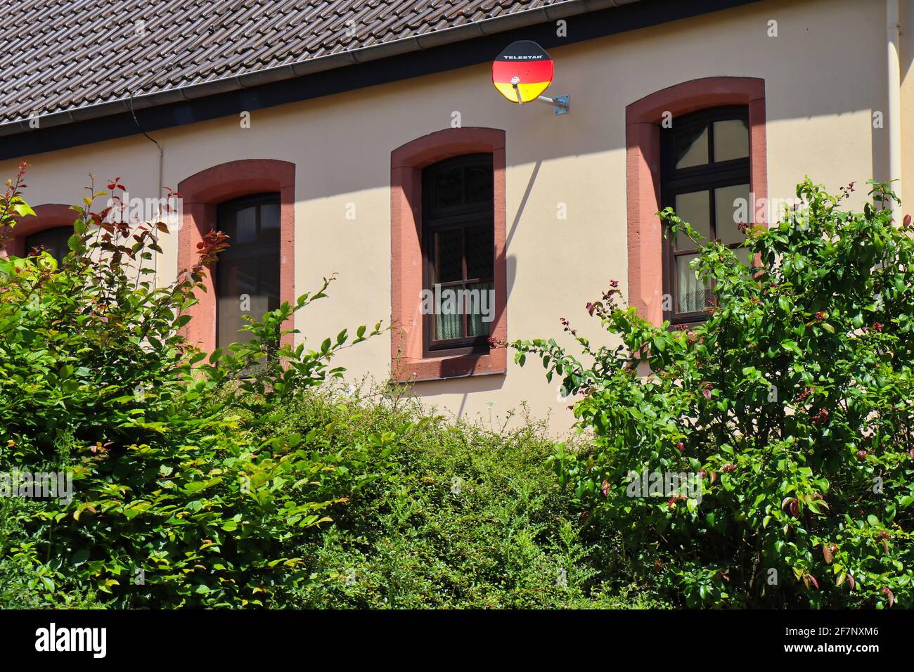 Dish with German flag on a traditional house in a small German village ...